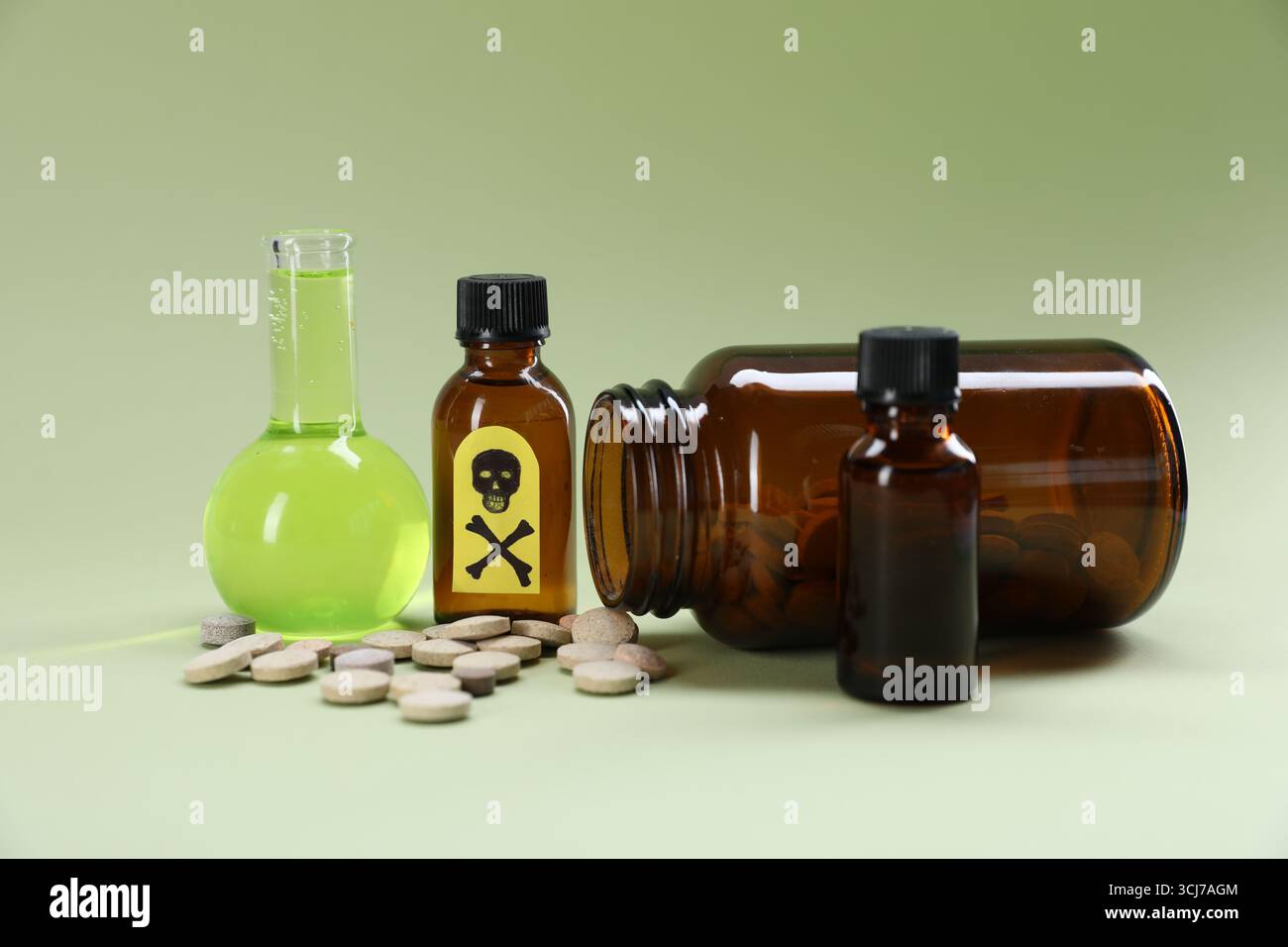 Bottles of poisons with warning sign on pale olive background Stock ...