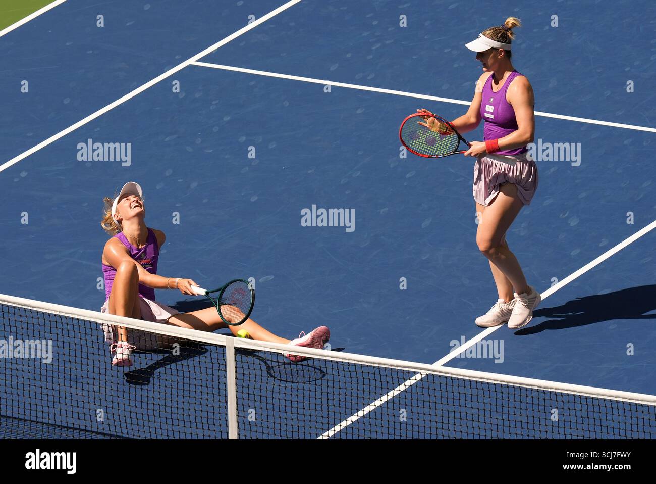Erin Routliffe, of New Zealand, left, and Gabriela Dabrowski, of Canada, react after a rally ...