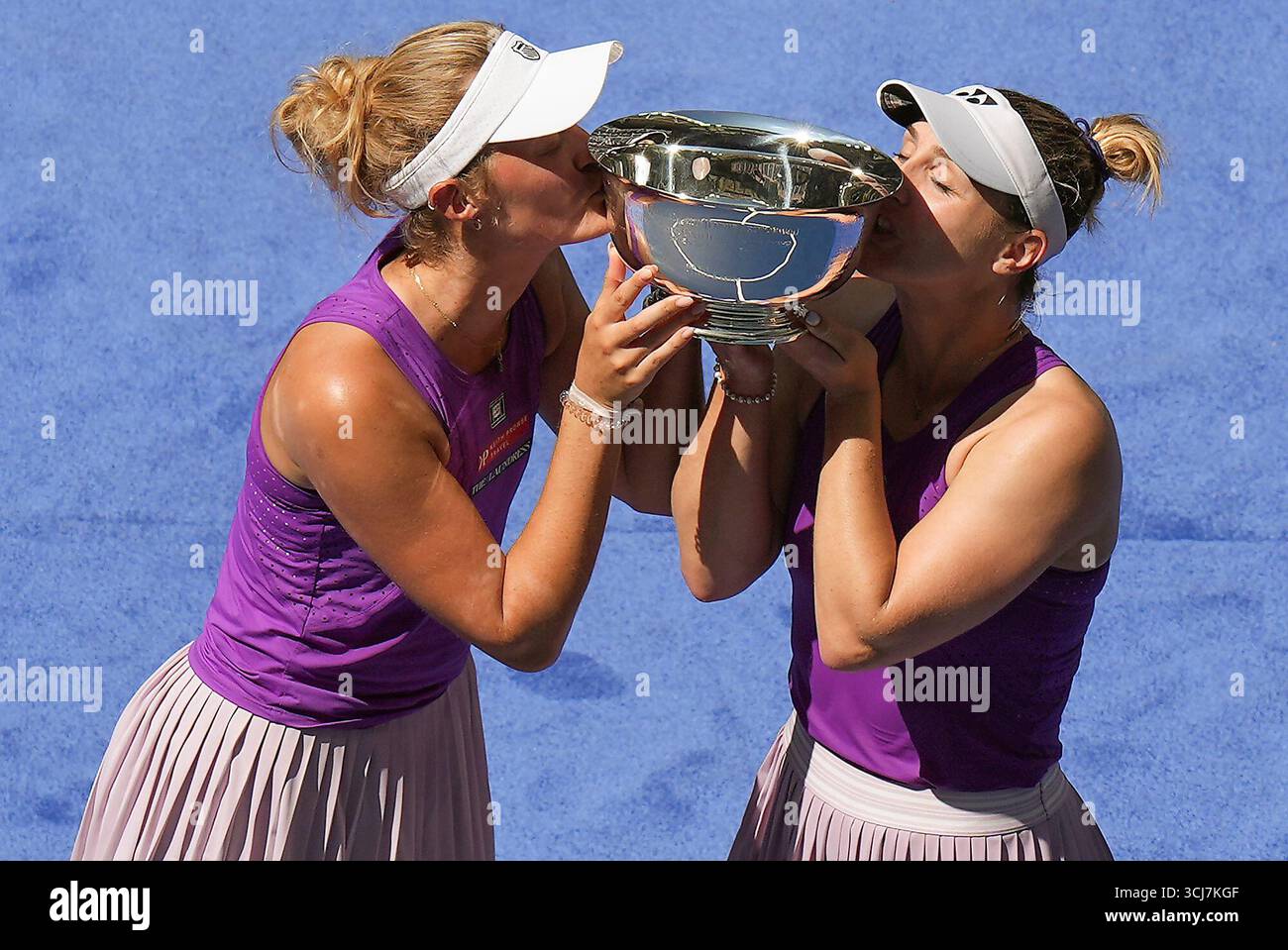 Erin Routliffe, of New Zealand, left, and Gabriela Dabrowski, of Canada, kiss the championship ...