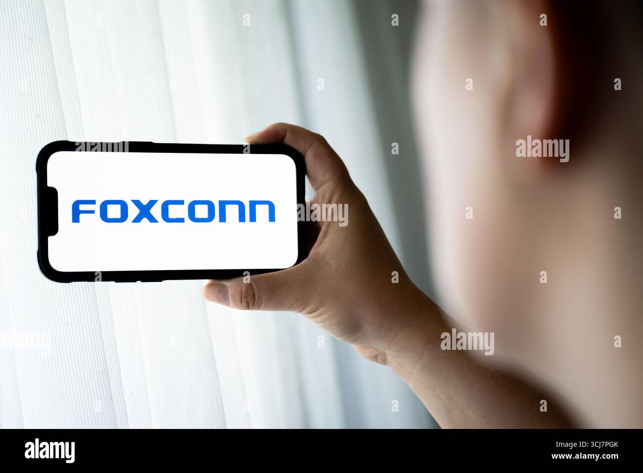 In this photo illustration, a Foxconn logo seen displayed on a ...