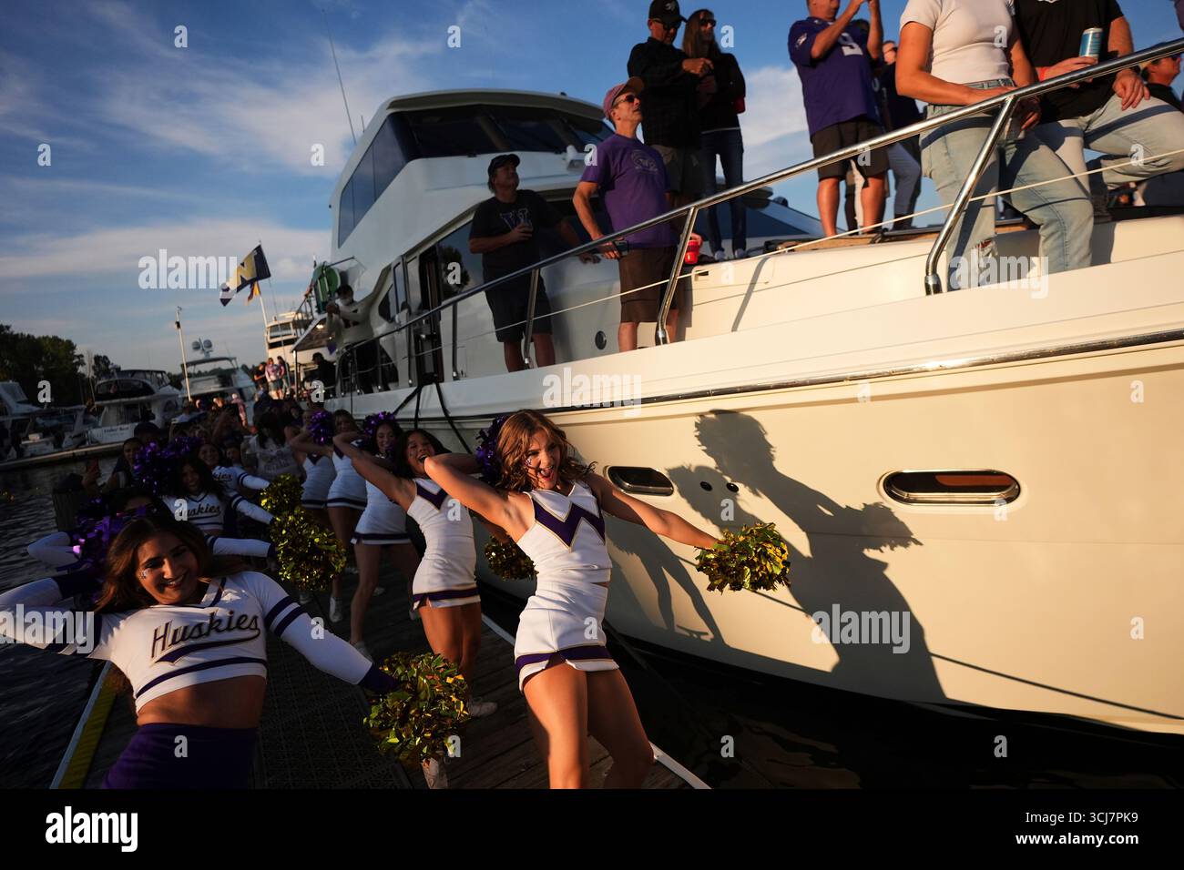 Washington cheerleaders perform for fans tailgating on boats, known as ...