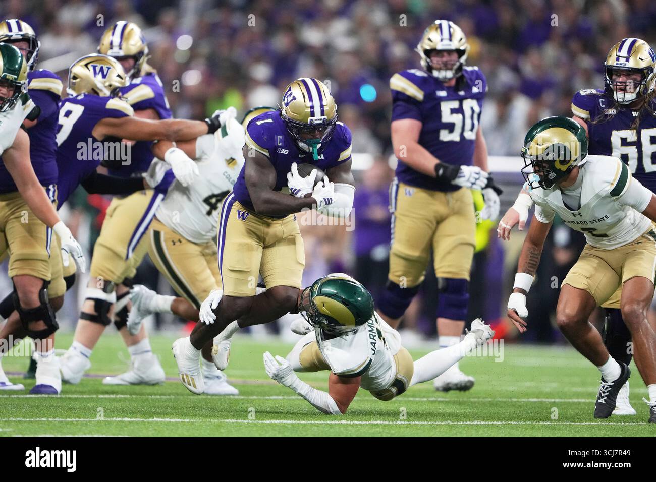 Washington running back Jonah Coleman runs the ball against Colorado State defensive back Jake ...