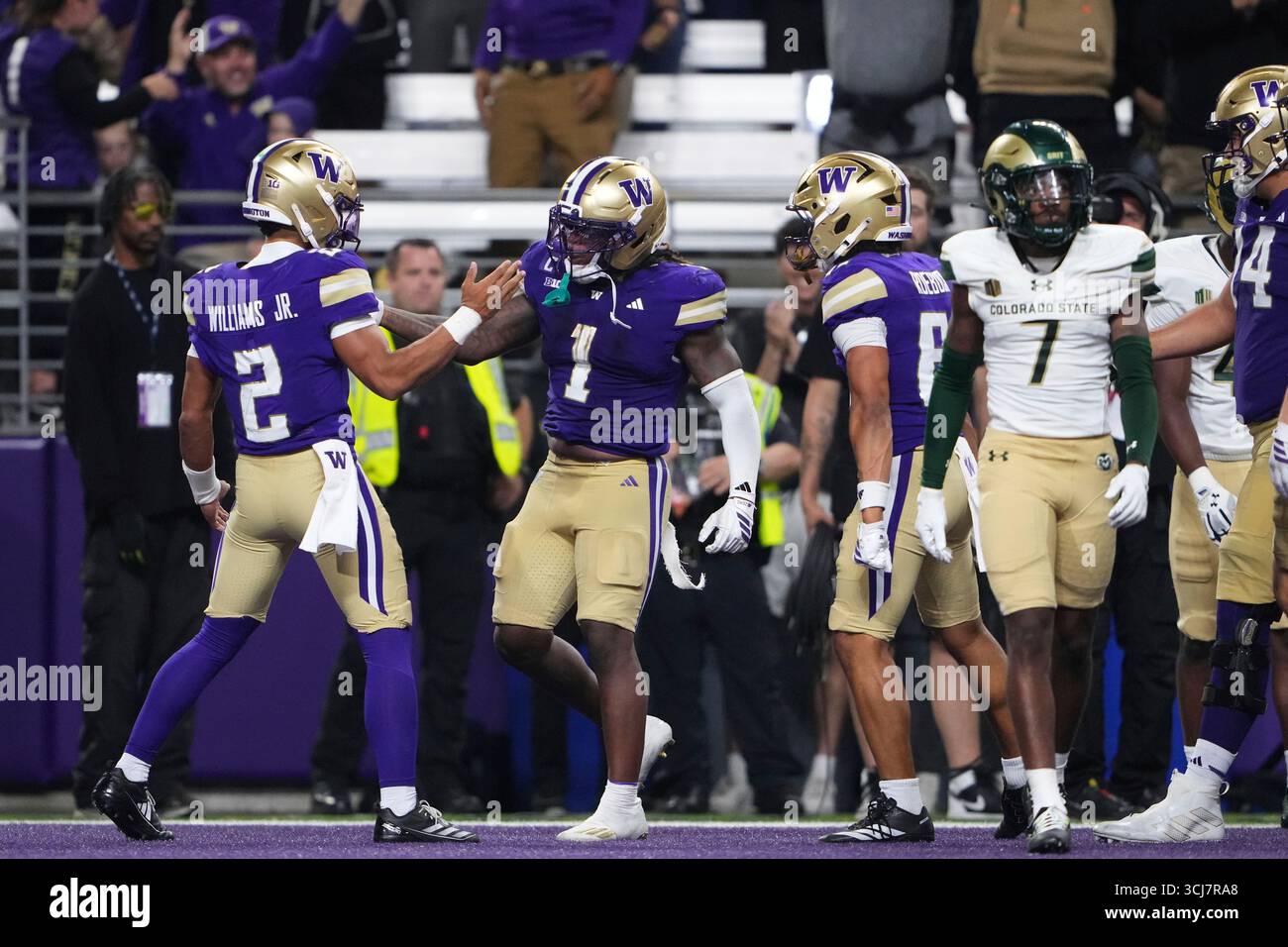 Washington running back Jonah Coleman (1) greets quarterback Demond ...