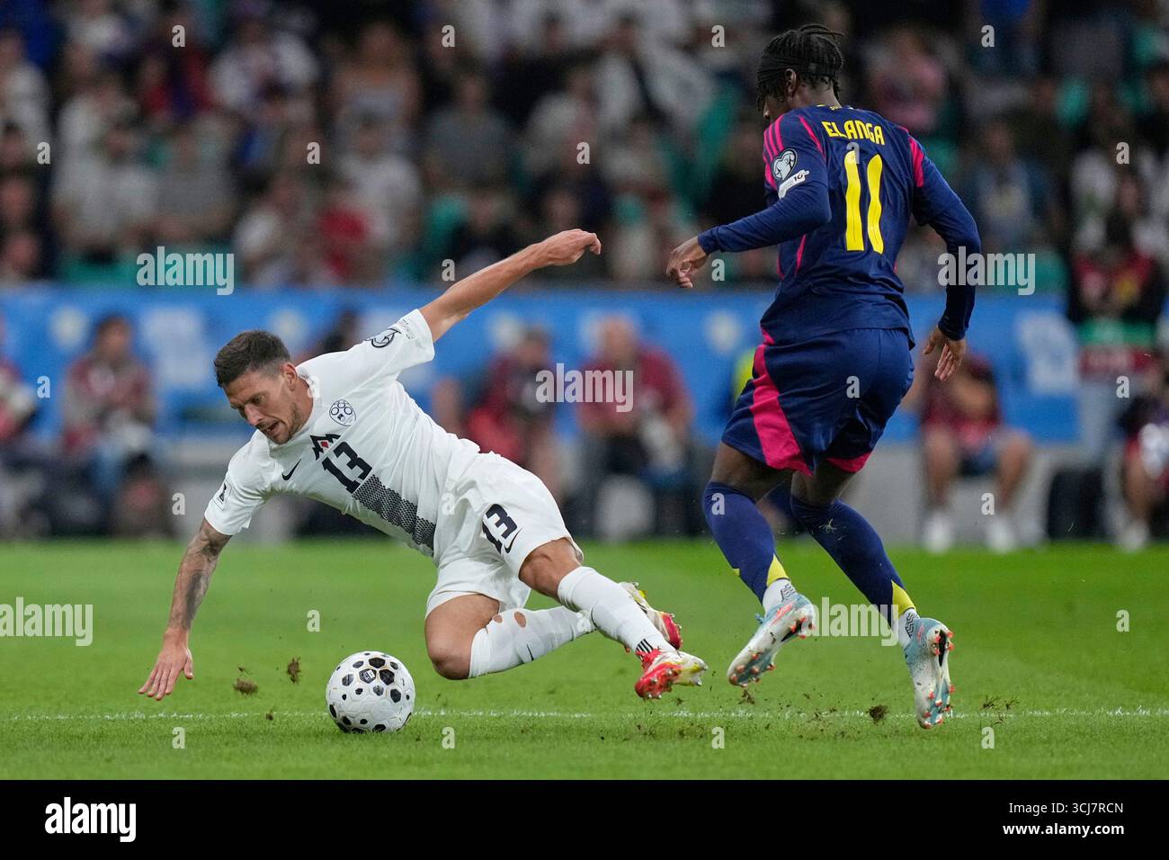 Slovenia's Erik Janza, left, and Sweden's Anthony Elanga fight for the ...