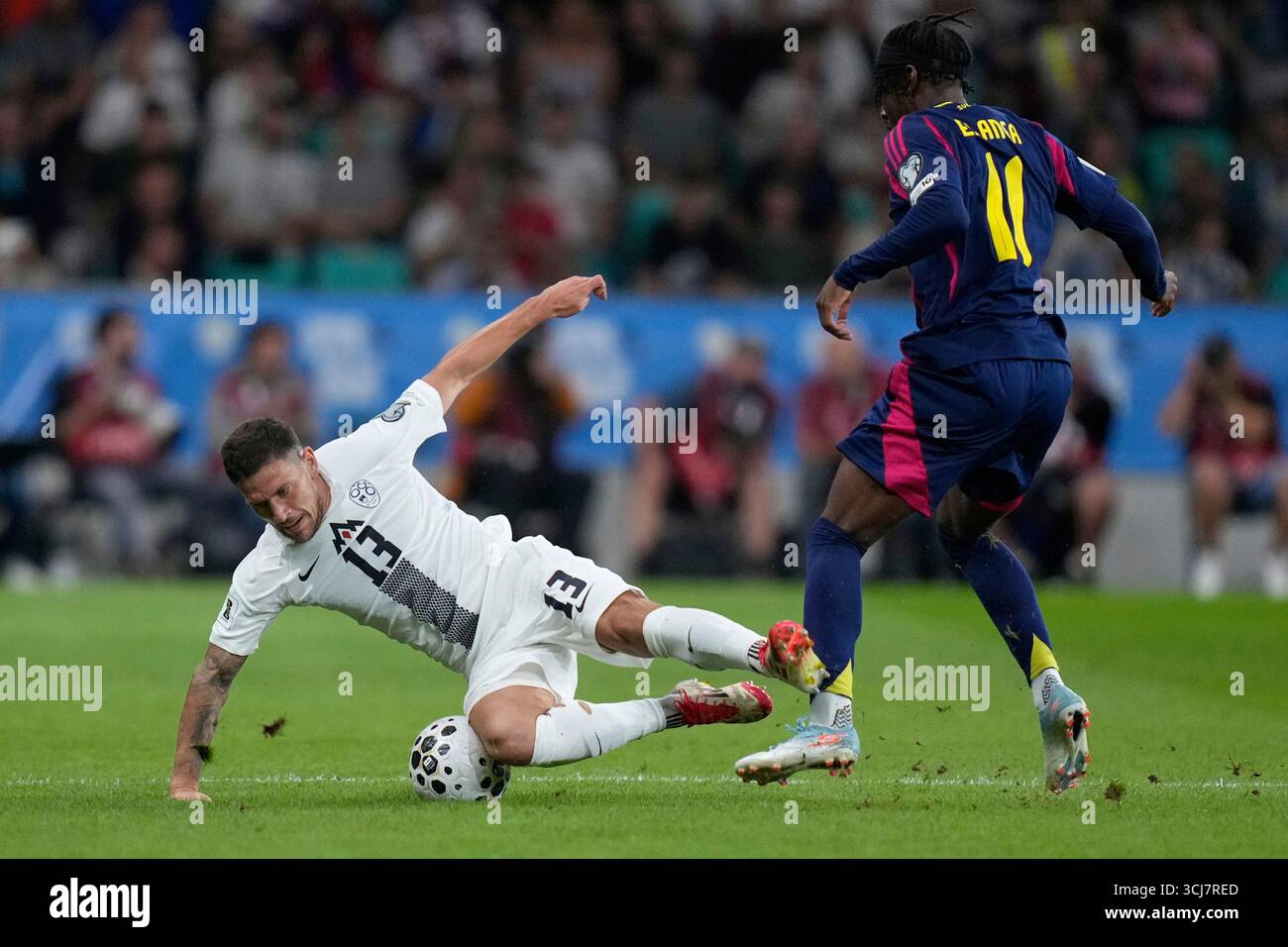 Slovenia's Erik Janza, left, and Sweden's Anthony Elanga fight for the ...