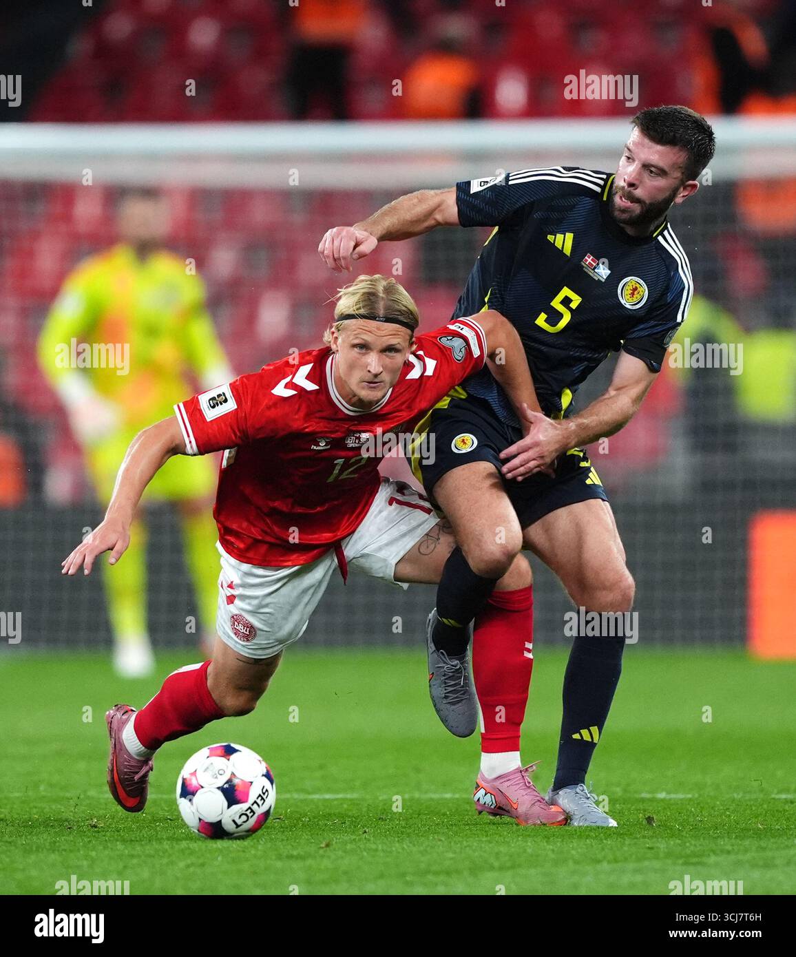 Denmark's Kasper Dolberg (left) and Scotland's Grant Hanley battle for ...