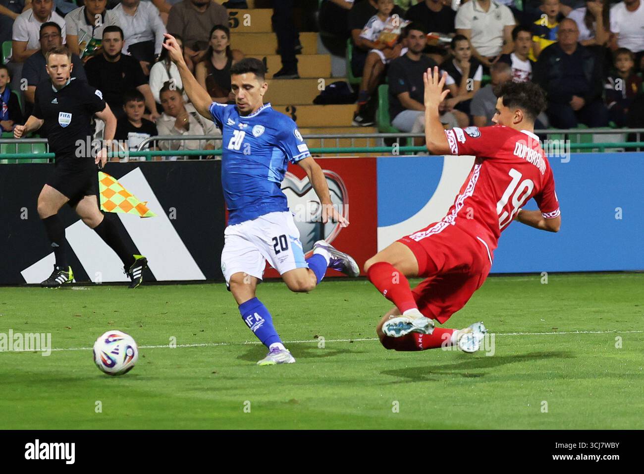 Israel's Dan Biton, left, challenges for the ball with Moldova's Daniel ...