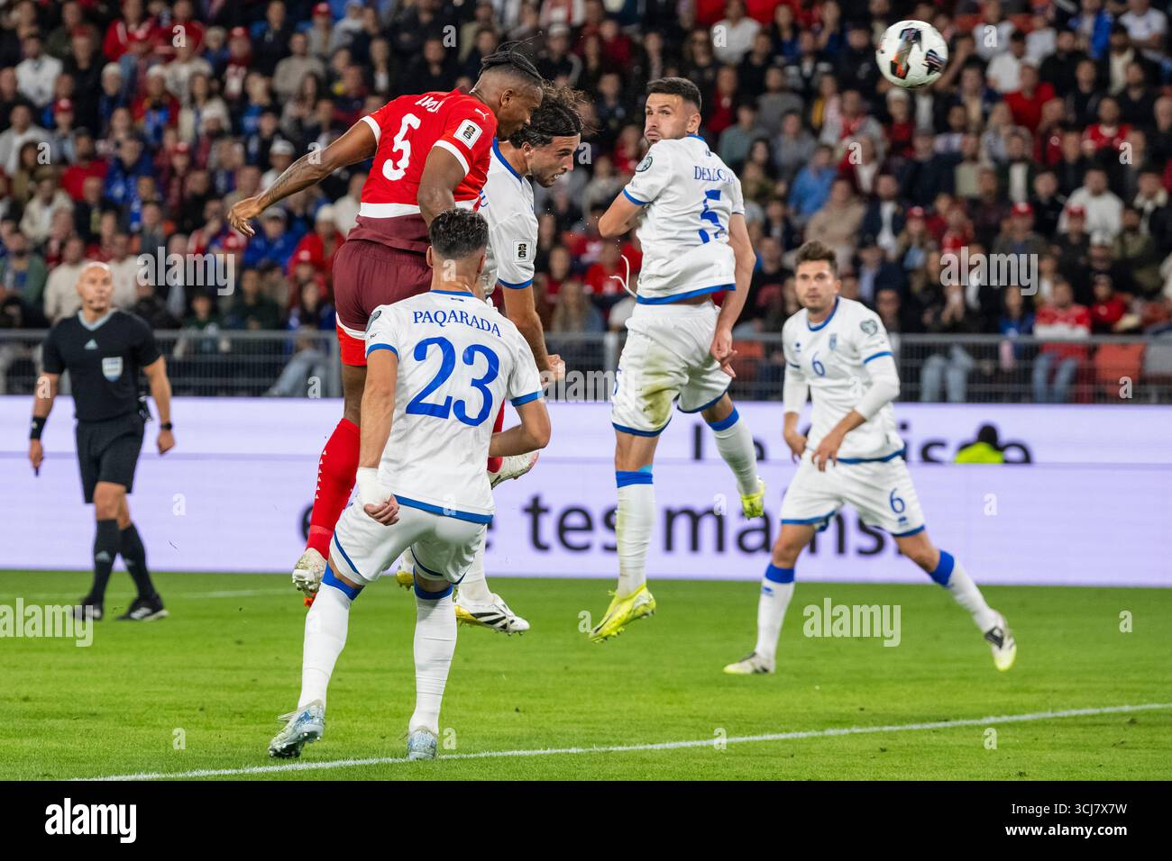 Switzerland's Manuel Akanji, top left, scores with a header against from right, Kosovo's Elvis ...