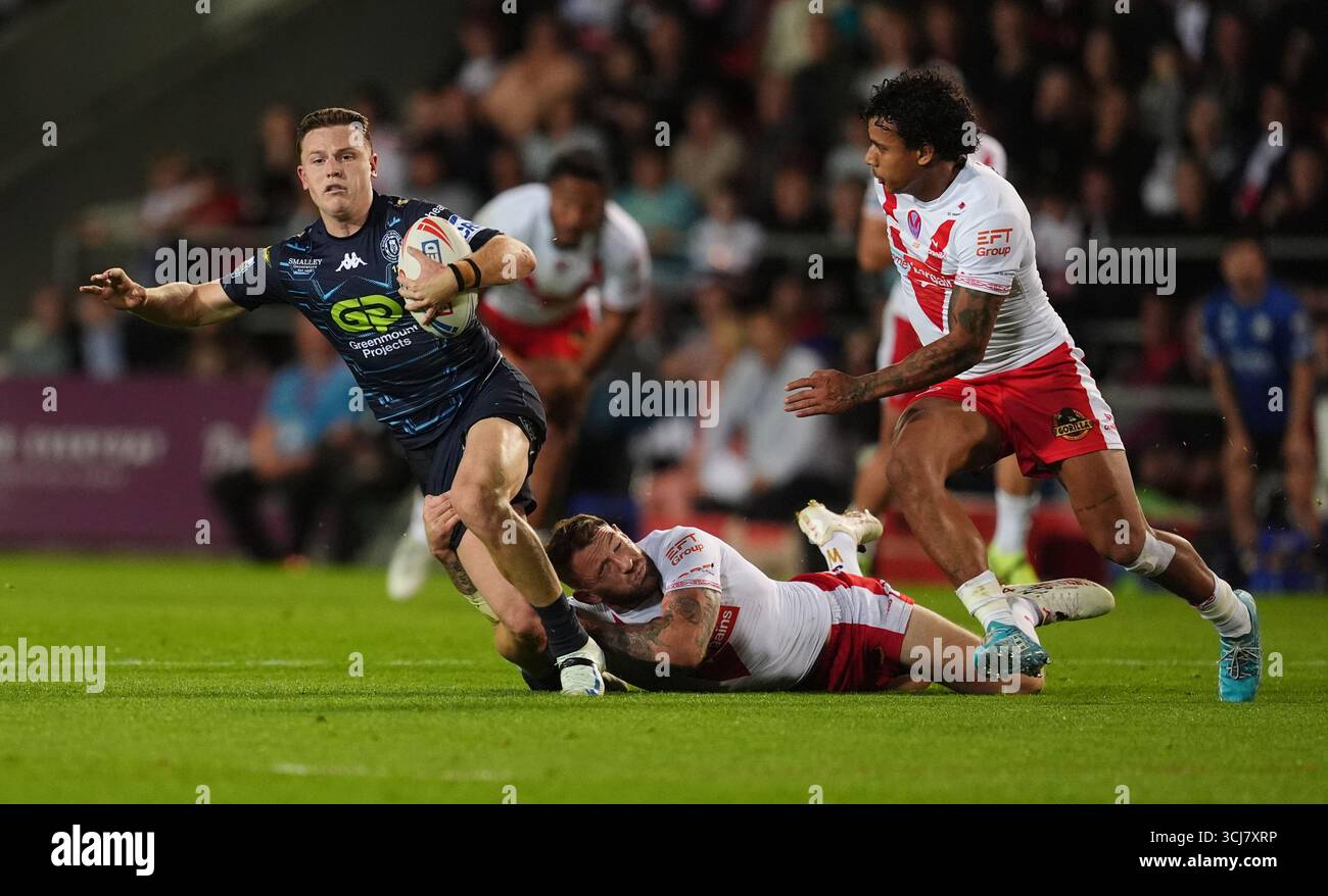 Wigan Warriors' Jai Field is tackled by St Helen's Daryl Clark during ...