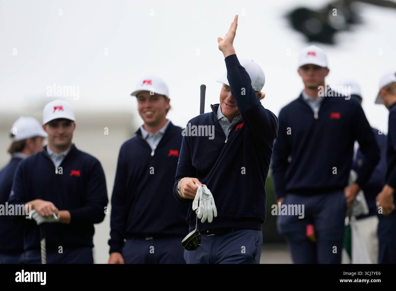 The Great Britain and Ireland team's Luke Poulter, middle, waves during ...