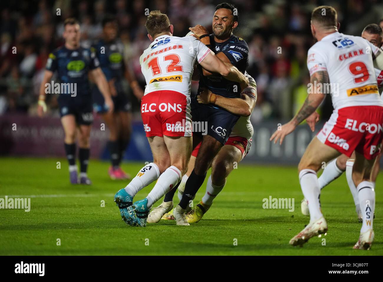Wigan Warriors' Bevan French is tackled by St Helen's Joe Batchelor ...