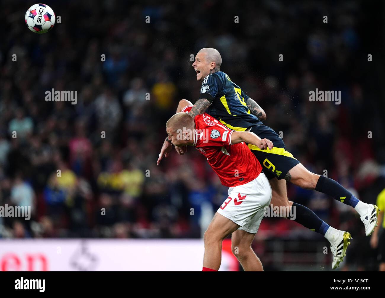 Denmark's Rasmus Kristensen and Scotland's Lyndon Dykes battle for the ...