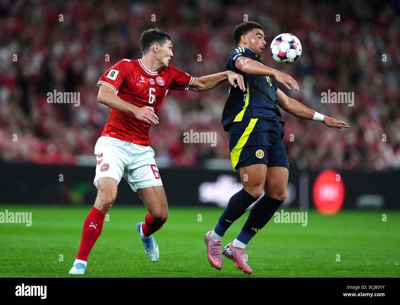 Denmark's Andreas Christensen (left) and Scotland's Che Adams battle ...