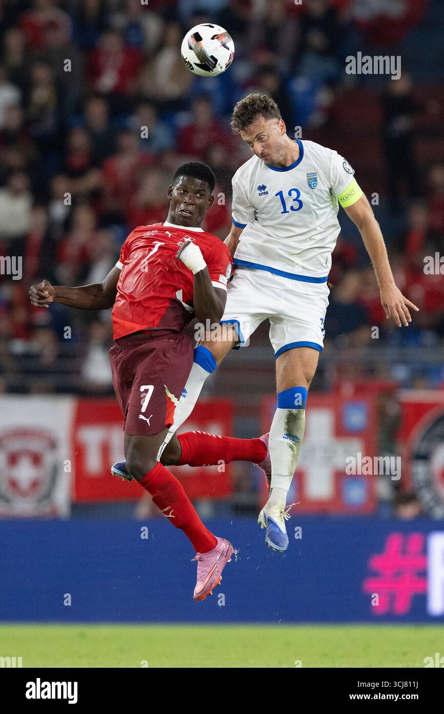 Switzerland's Breel Embolo, left, against Kosovo's Amir Rrahmani, right ...