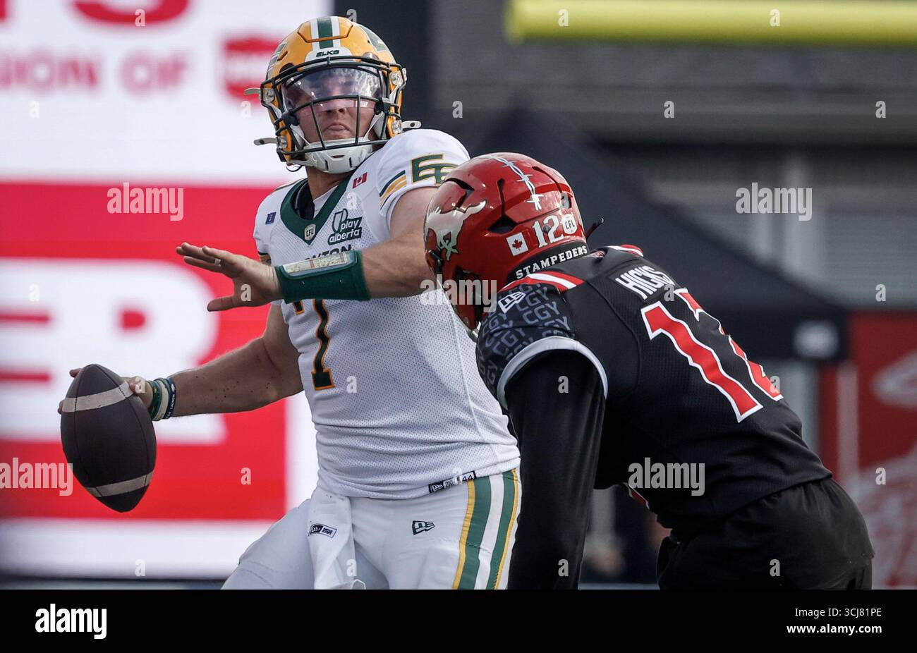 Edmonton Elks quarterback Cody Fajardo, left, looks for a receiver as ...