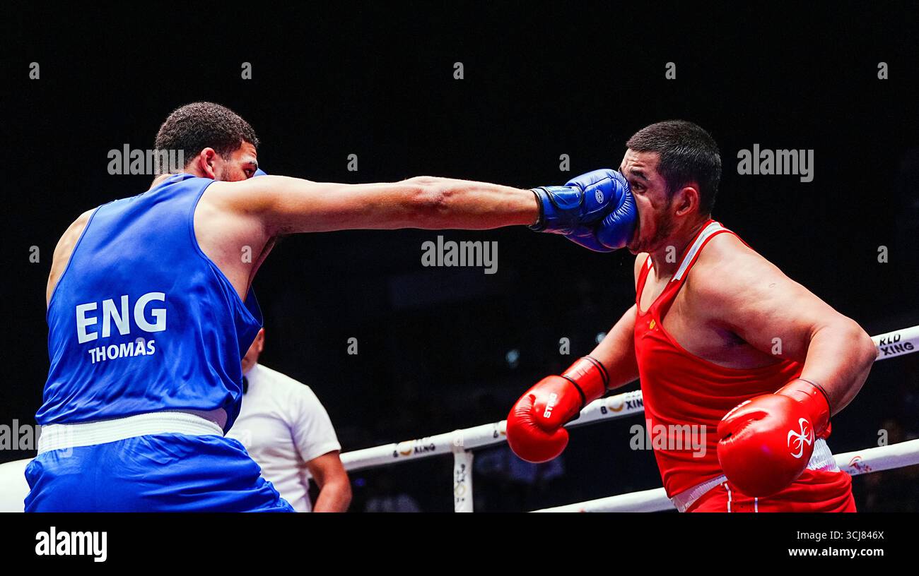 England's Damar Thomas (BLUE) and Kyrgyzstan's Myrzakir Koshaliev (RED) compete in the Men's ...