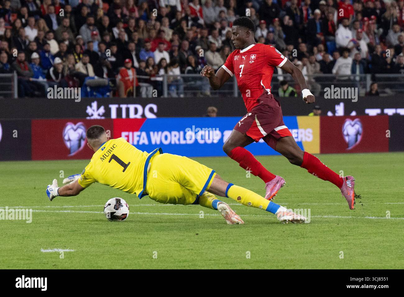 Switzerland's Breel Embolo, right, against Kosovo's goalkeeper Arijanet ...