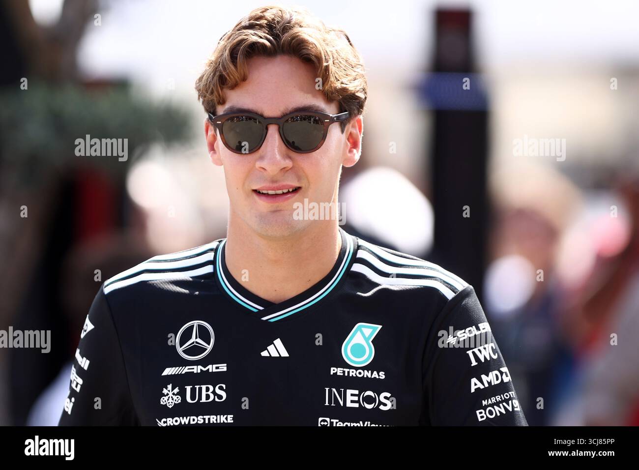 George Russell of Mercedes-AMG F1 Team looks on in the Paddock during ...