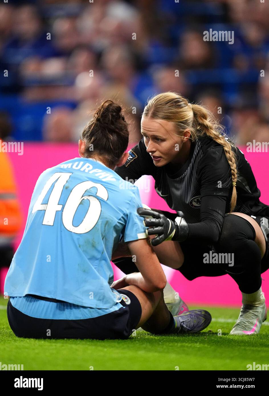 Manchester City's Lily Murphy is checked on by Chelsea goalkeeper ...