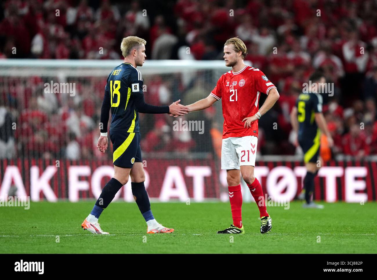 Scotland's George Hirst (left) greets Denmark's Morten Hjulmand ...