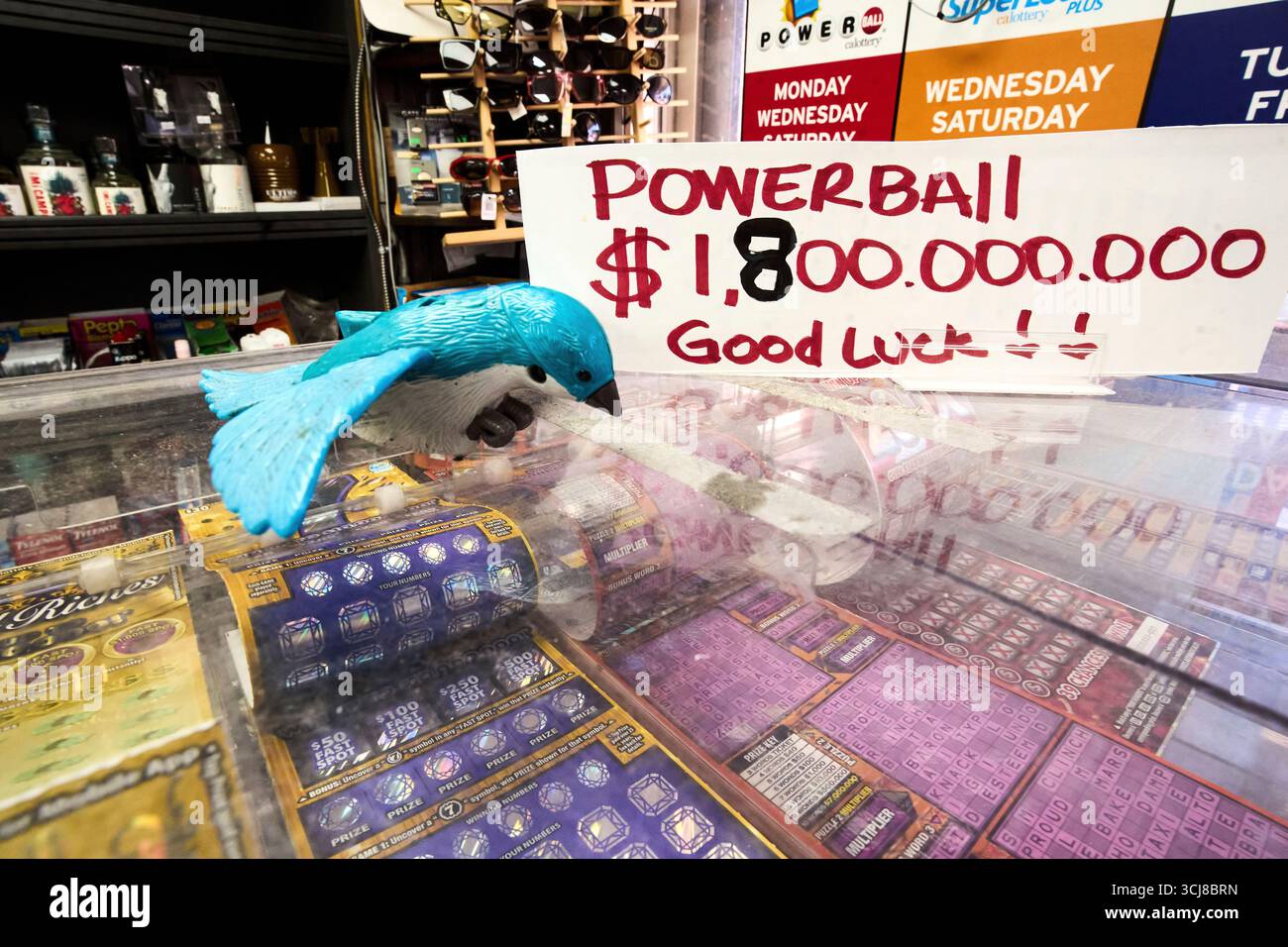 A sign reads "Powerball $1,800,000,000 Good Luck!" at the Bluebird ...