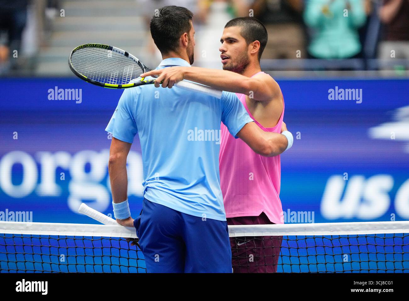 Carlos Alcaraz, of Spain, hugs Novak Djokovic, of Serbia, after ...