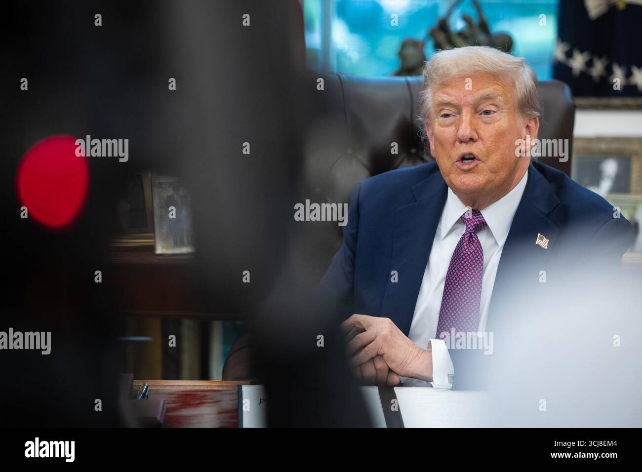 President Donald Trump speaks with reporters in the Oval Office at the ...