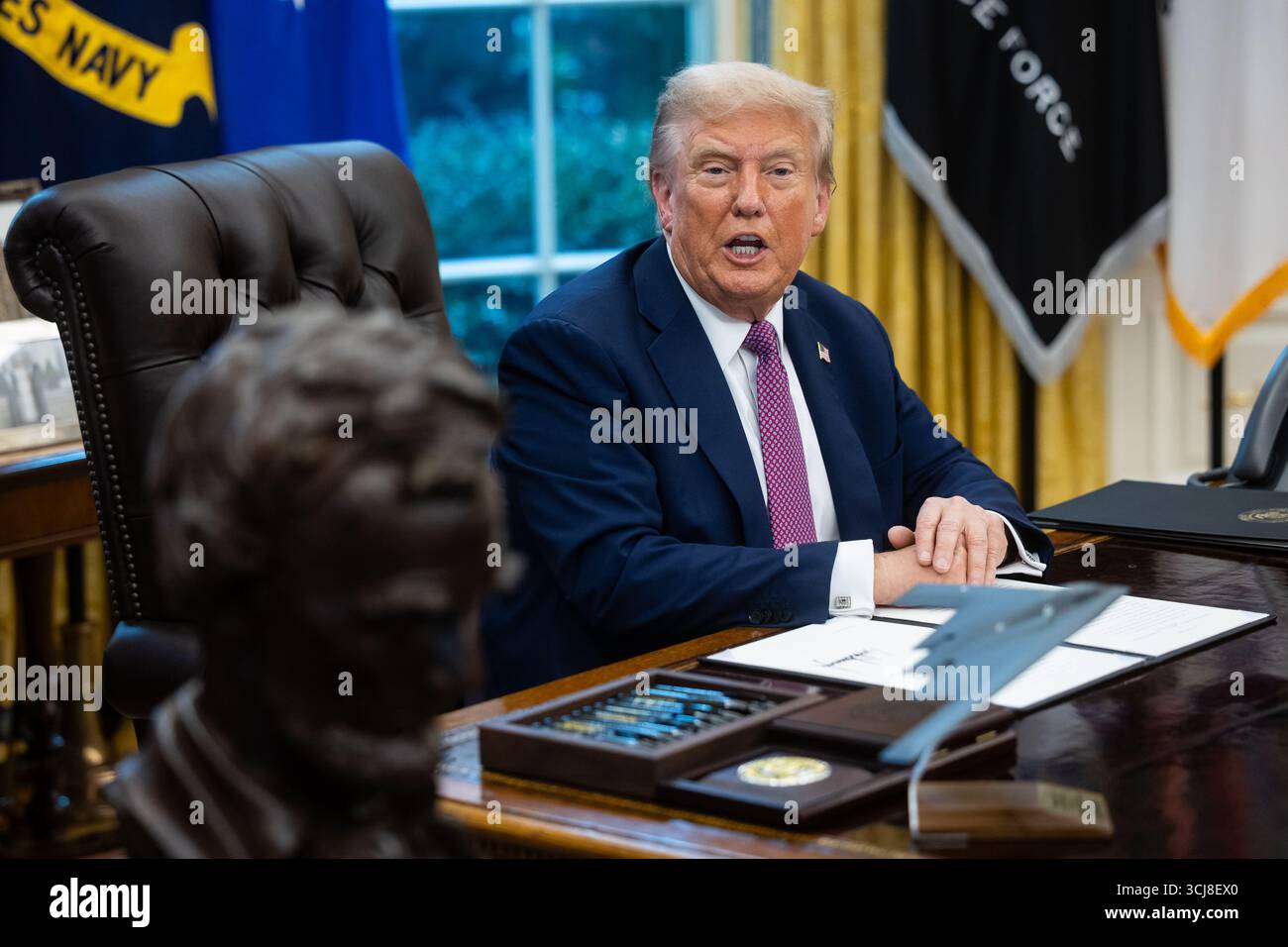 President Donald Trump speaks with reporters in the Oval Office at the ...