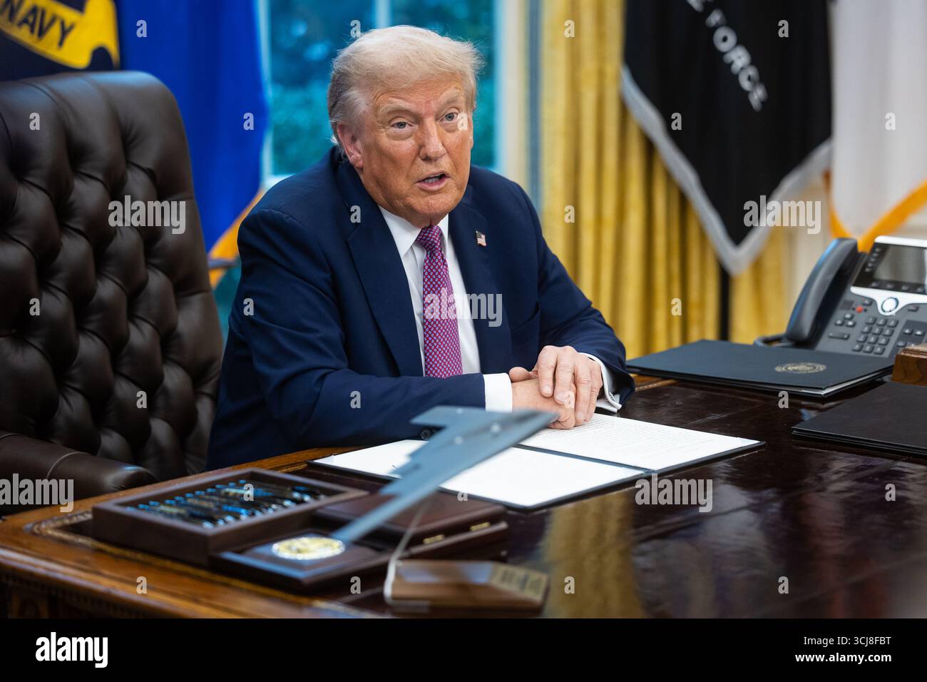 President Donald Trump speaks with reporters in the Oval Office at the ...