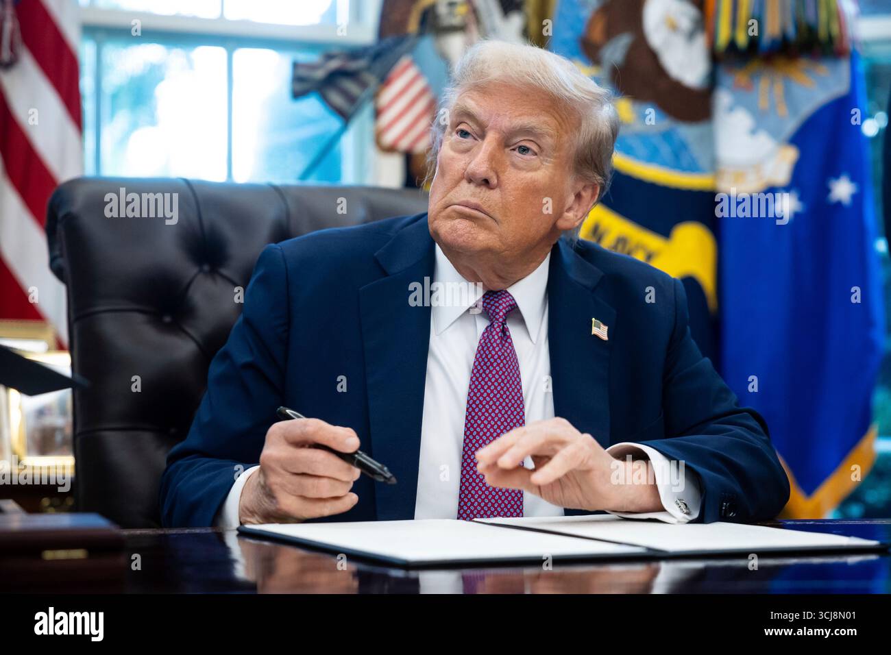 President Donald Trump signs and executive order in the Oval Office at ...