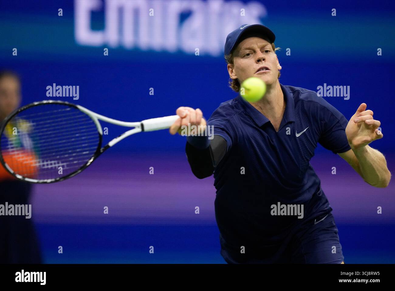 Jannik Sinner, of Italy, returns a shot against Felix Auger-Aliassime ...