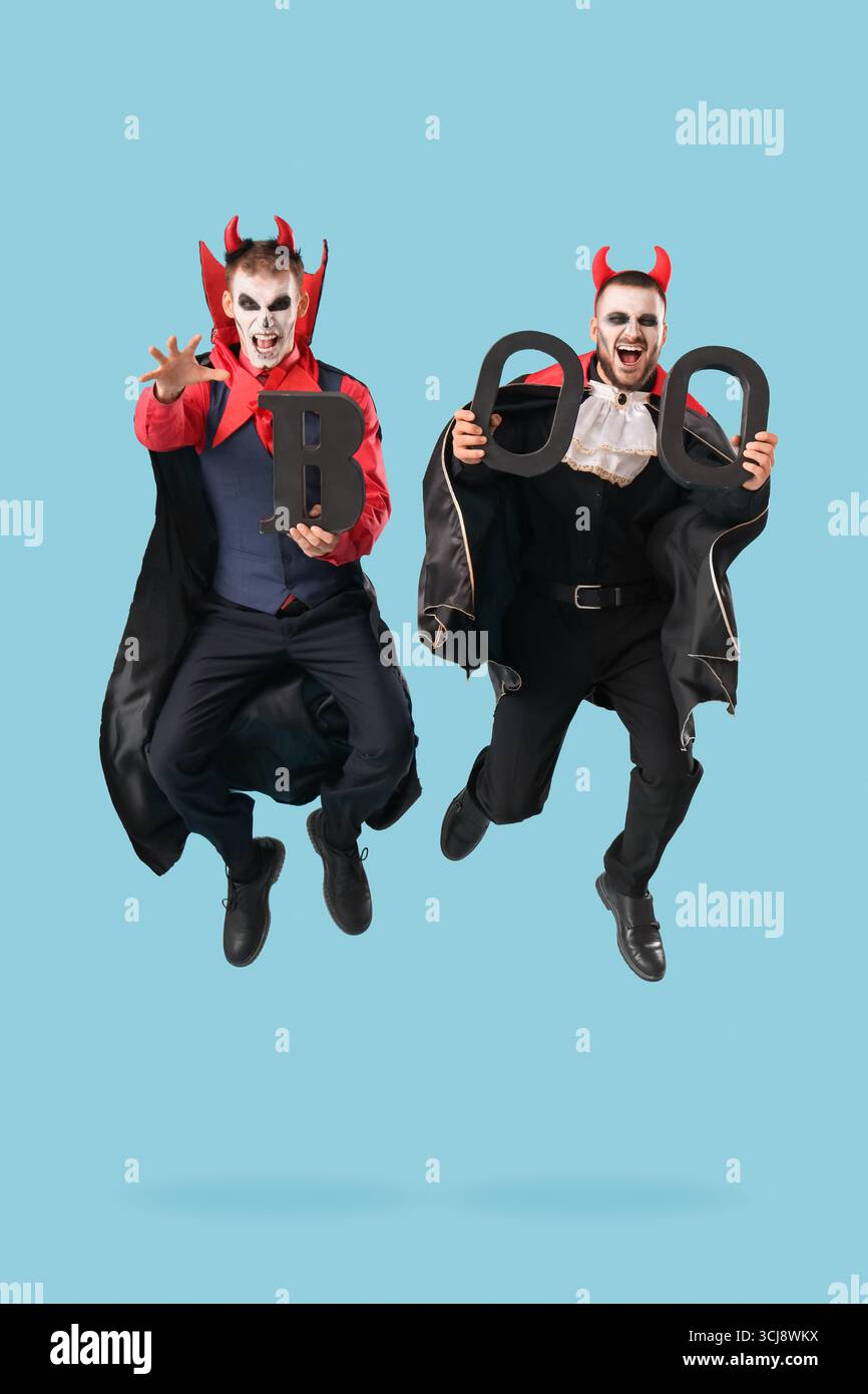 Scary men dressed as vampires for Halloween with word BOO jumping on ...