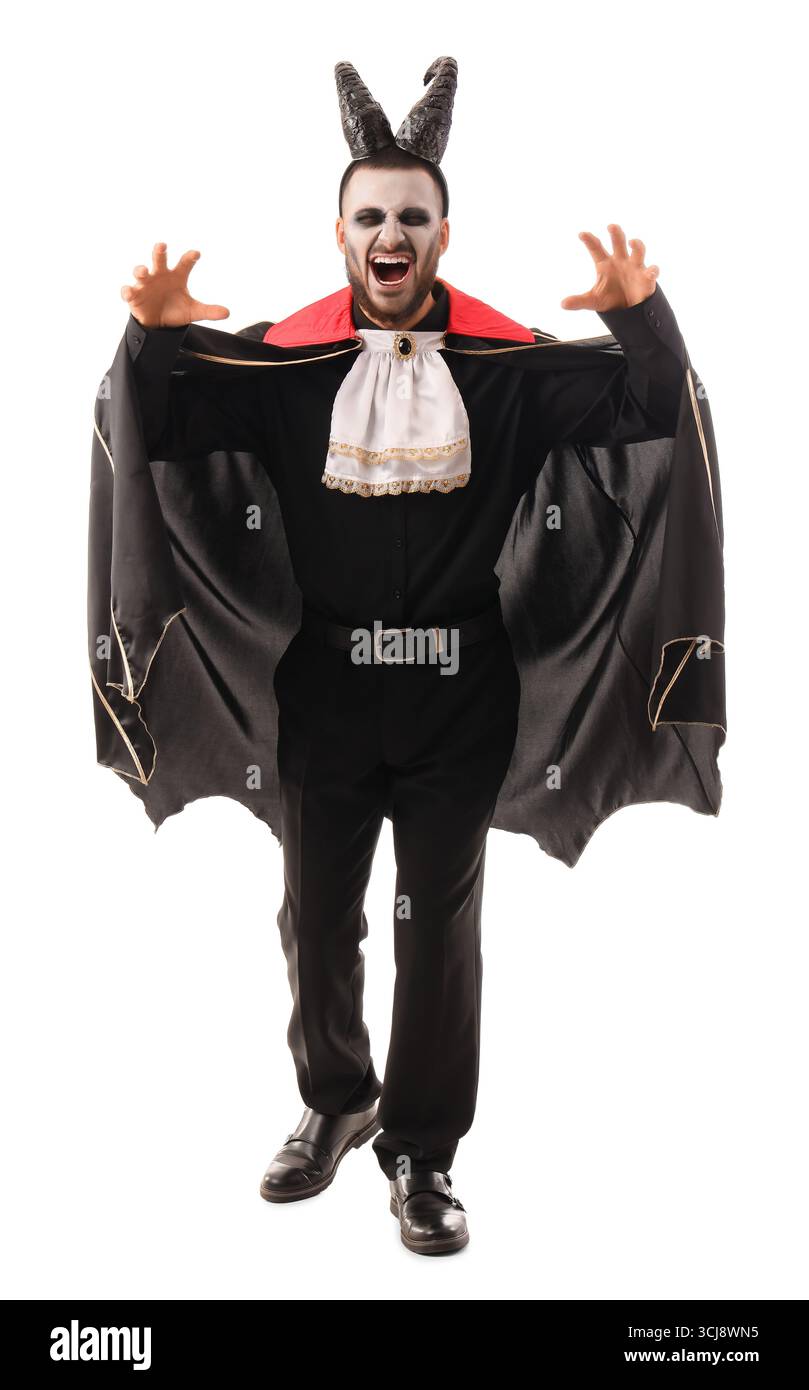 Young man dressed as vampire for Halloween with horns screaming on ...