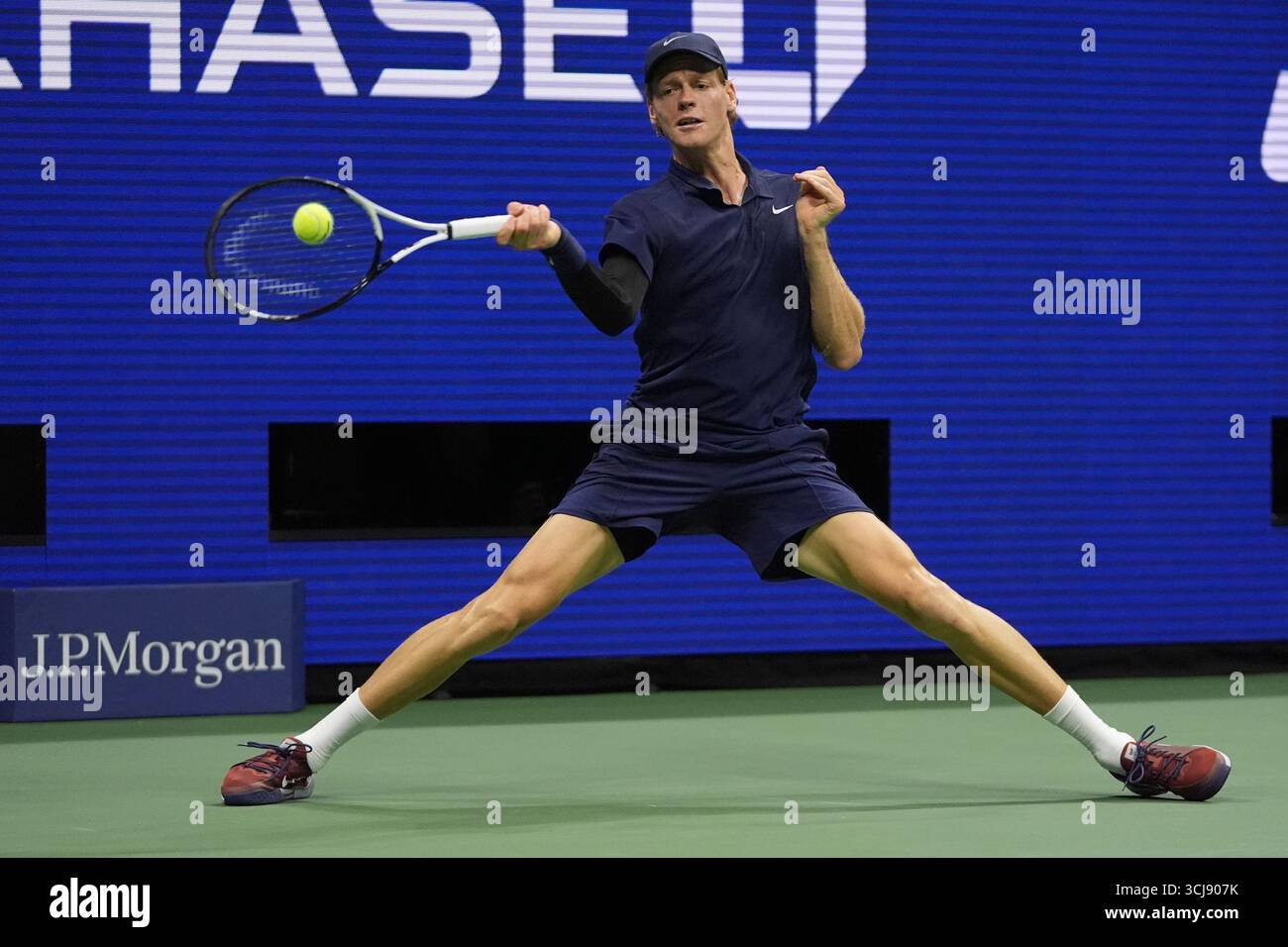 Jannik Sinner, of Italy, returns a shot against Felix Auger-Aliassime ...