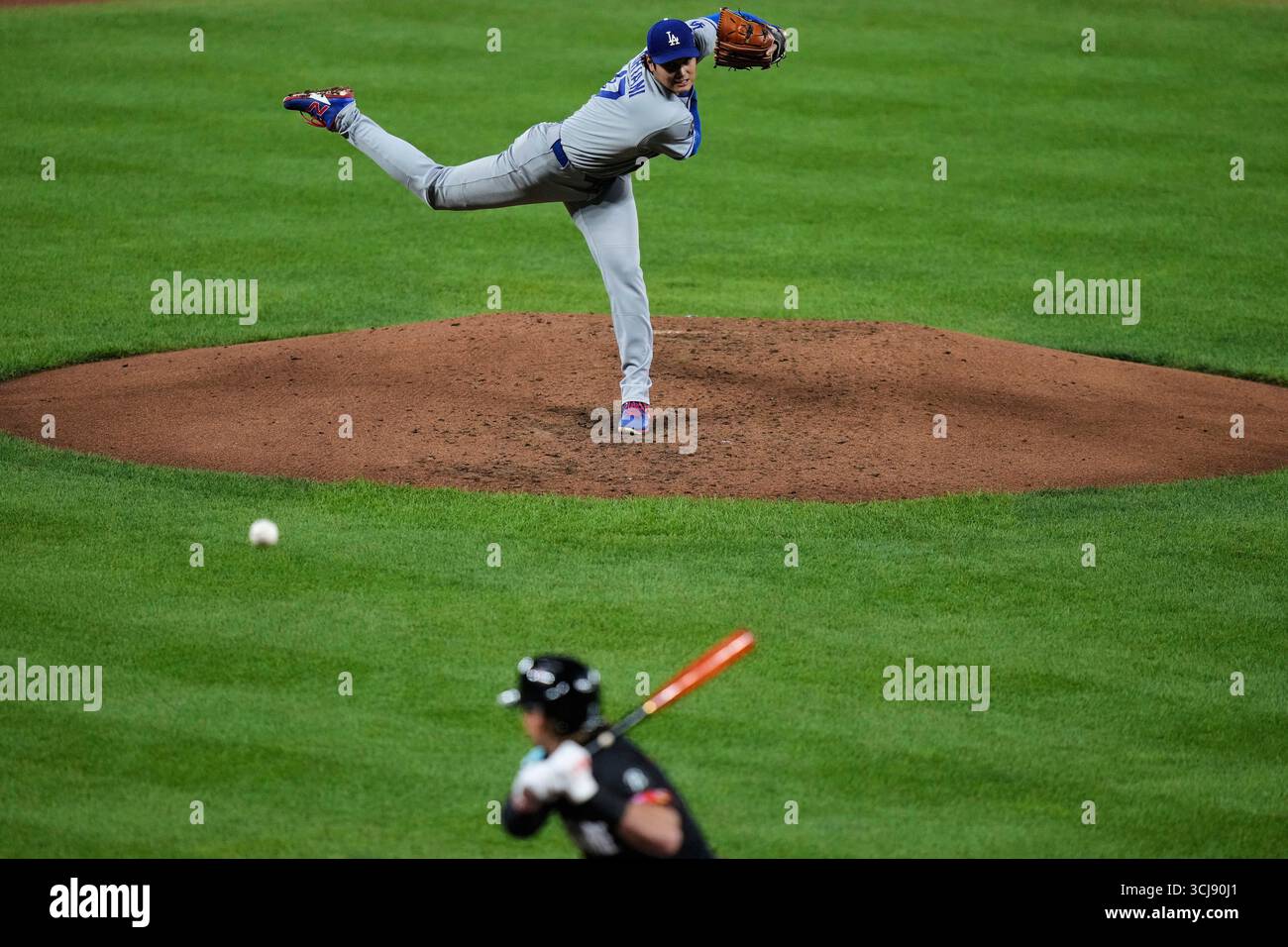 Los Angeles Dodgers starting pitcher Shohei Ohtani, top, delivers ...