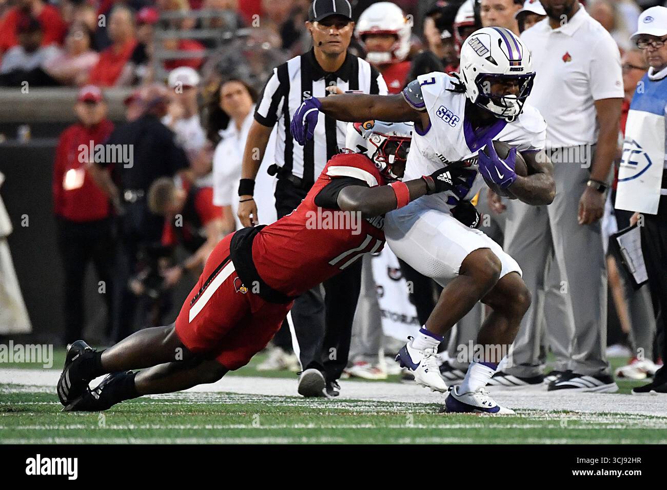 Louisville linebacker T.J. Capers (11) attempts to bring down James ...