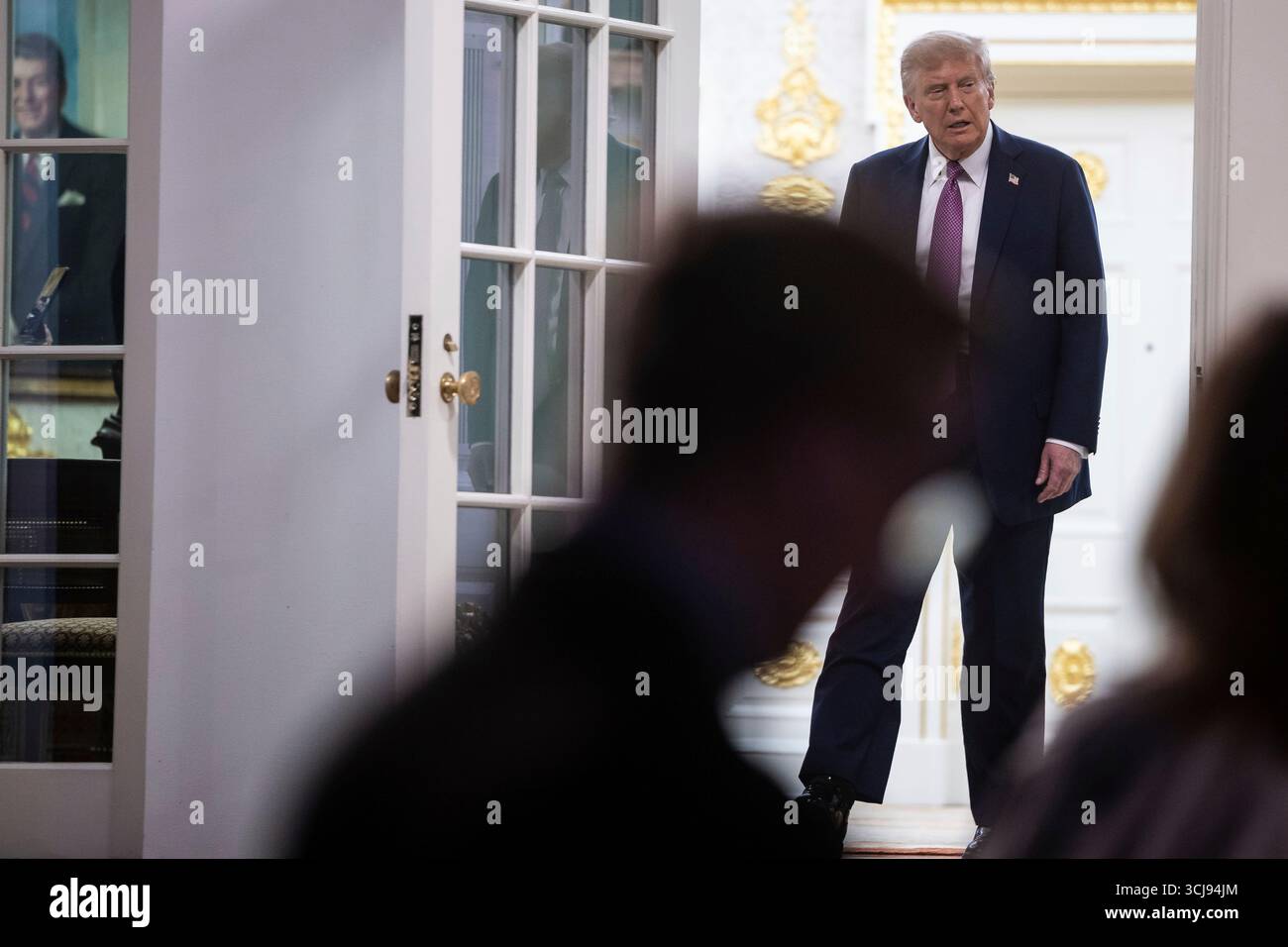 President Donald Trump emerges from the Oval Office to host a dinner ...