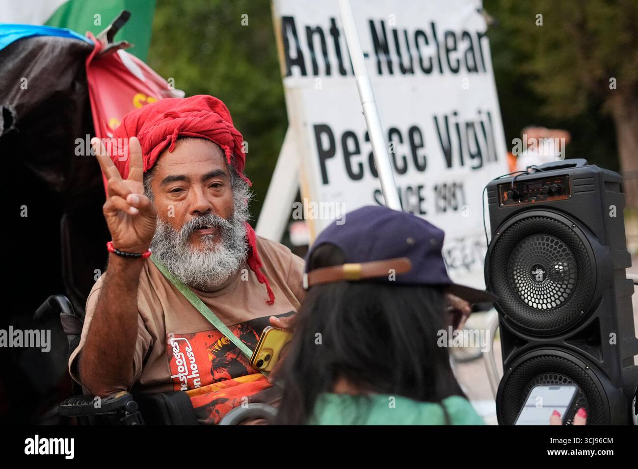 Philipos Melaku-Bello gestures the peace sign at the White House Peace Vigil in Lafayatte Park ...