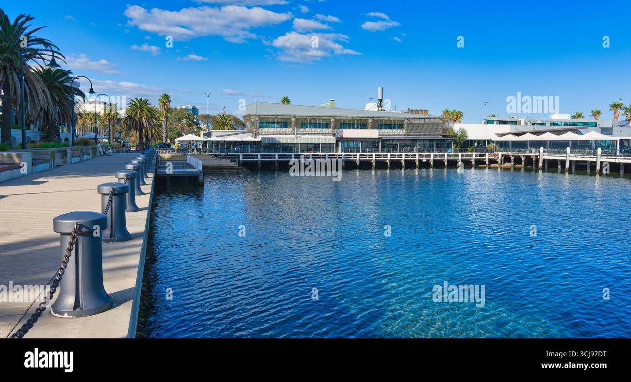 Palm tree lined esplanade with restaurants and waterfront boardwalk in ...