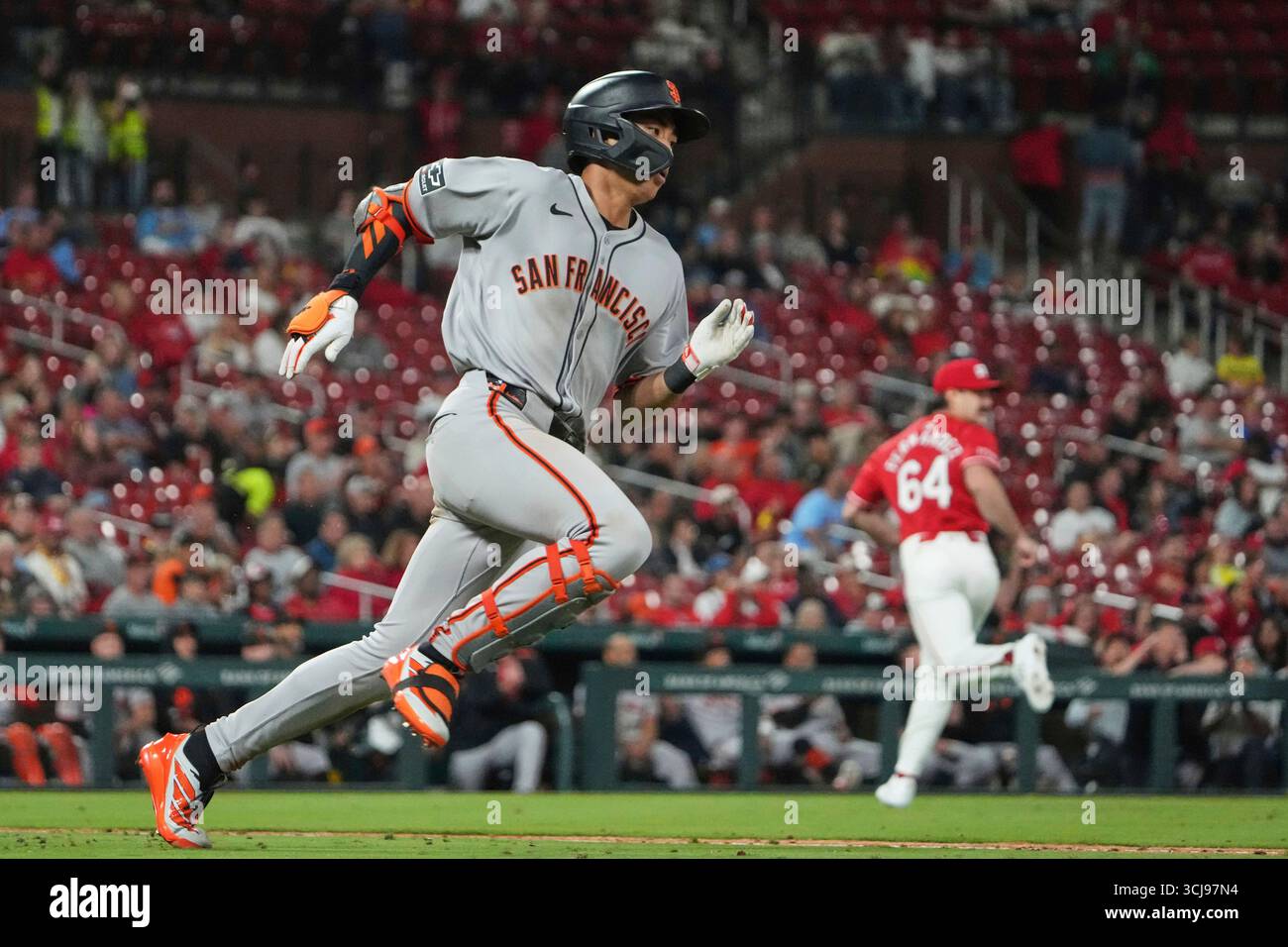 San Francisco Giants' Jung Hoo Lee, left, rounds first on an RBI triple ...