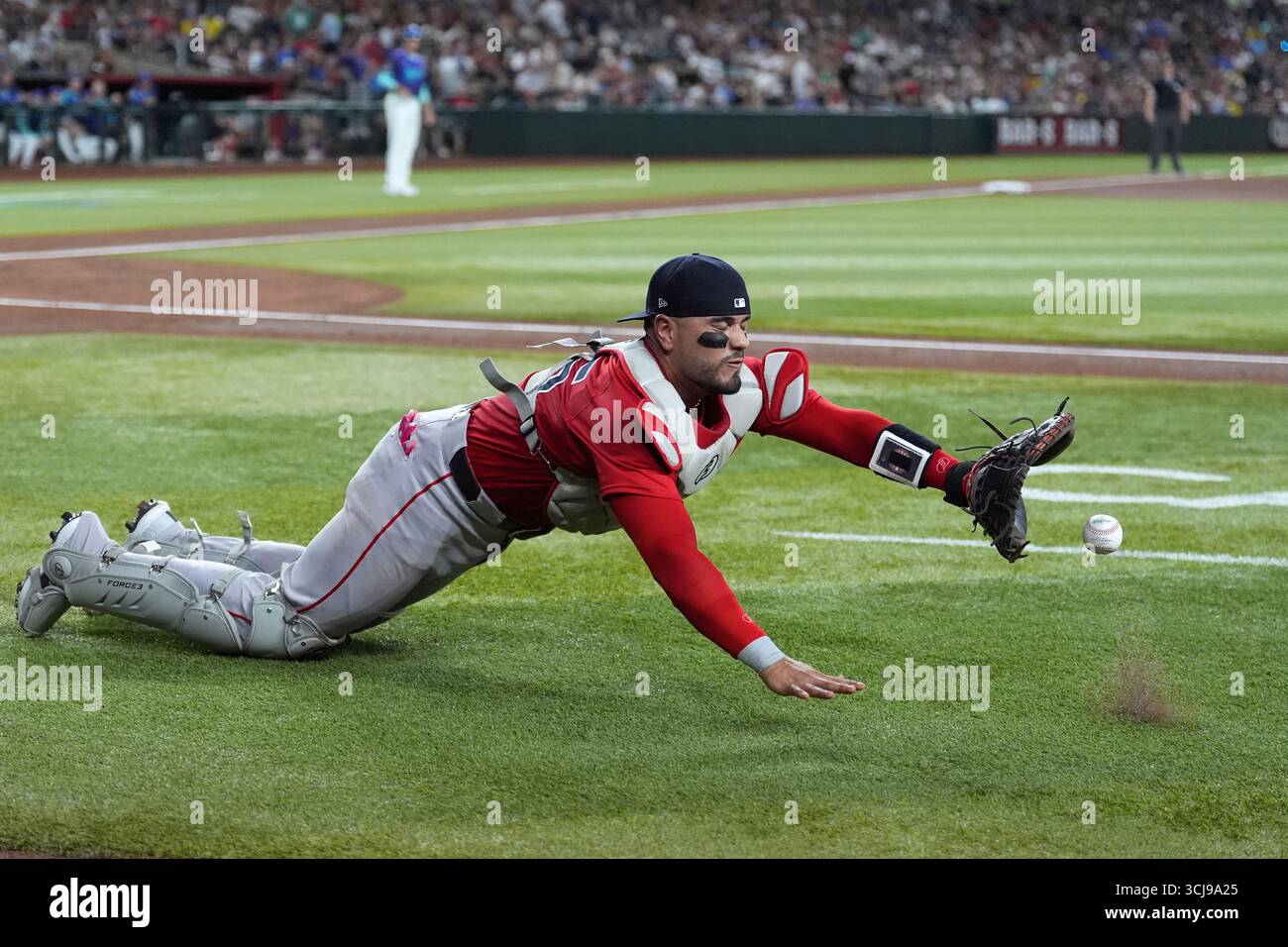 Boston Red Sox catcher Carlos Narváez dives but is unable to make a ...