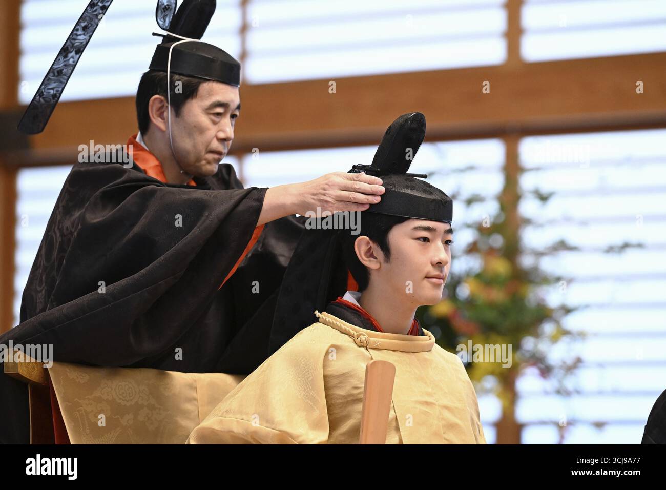 Japanese Prince Hisahito (R), in ceremonial attire, has a crown ...