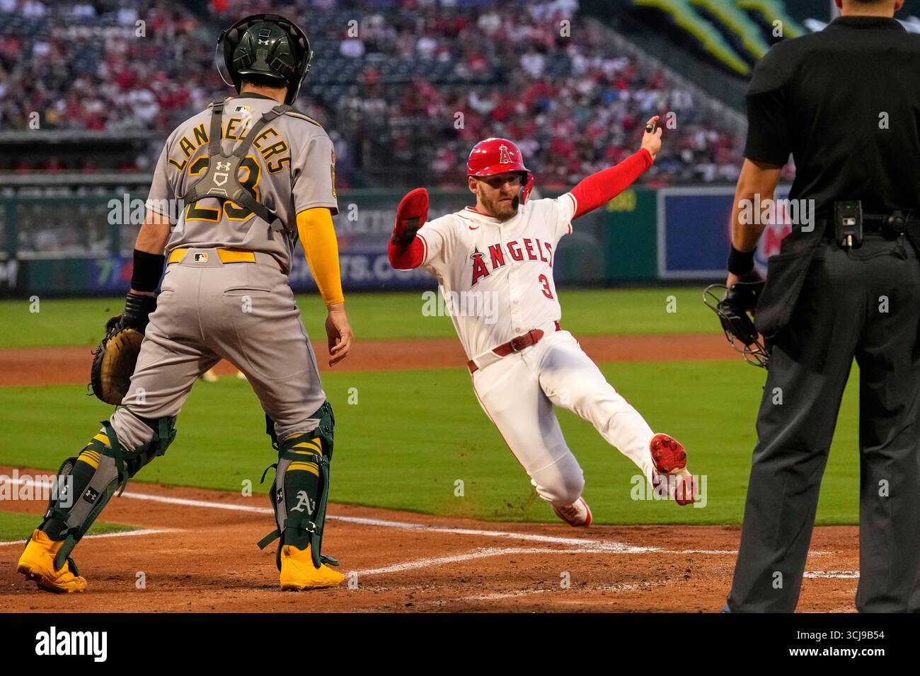 Los Angeles Angels' Taylor Ward,, center, scores on a single by Oswald ...