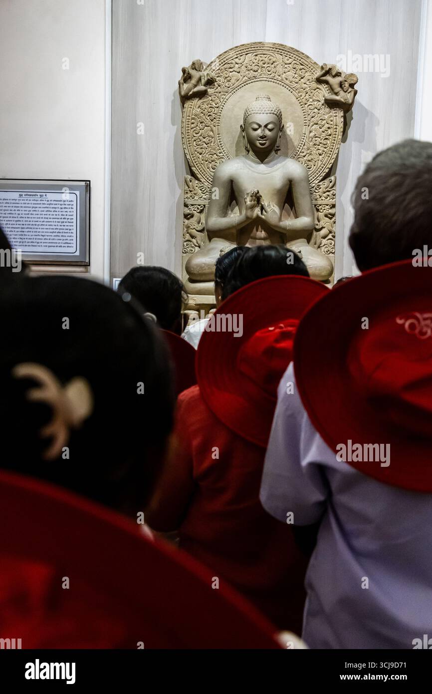 sacred buddha idol in teaching gesture with praying devotees image is ...
