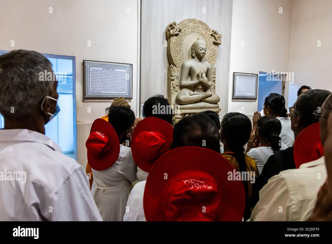 sacred buddha idol in teaching gesture with praying devotees image is ...