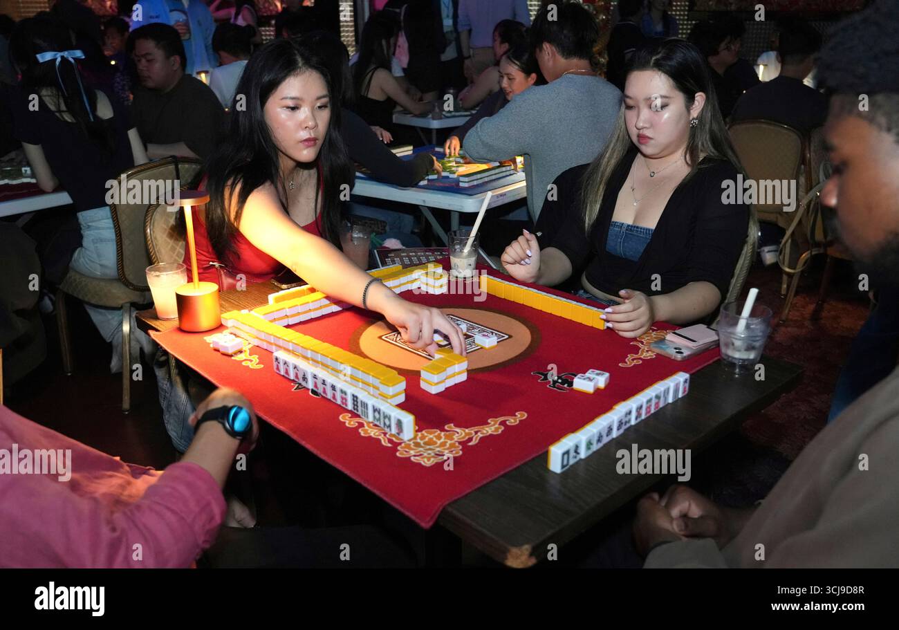 People play mahjong at an event organized by the YLL Mahjong Club on ...