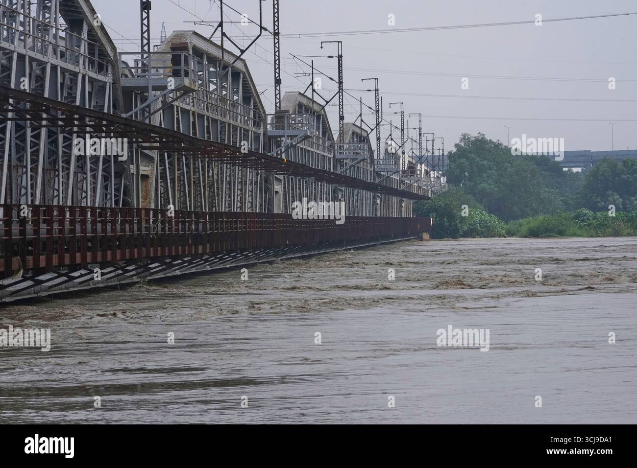 The swollen Yamuna river by incessant rain in the higher regions flows dangerously close to an ...
