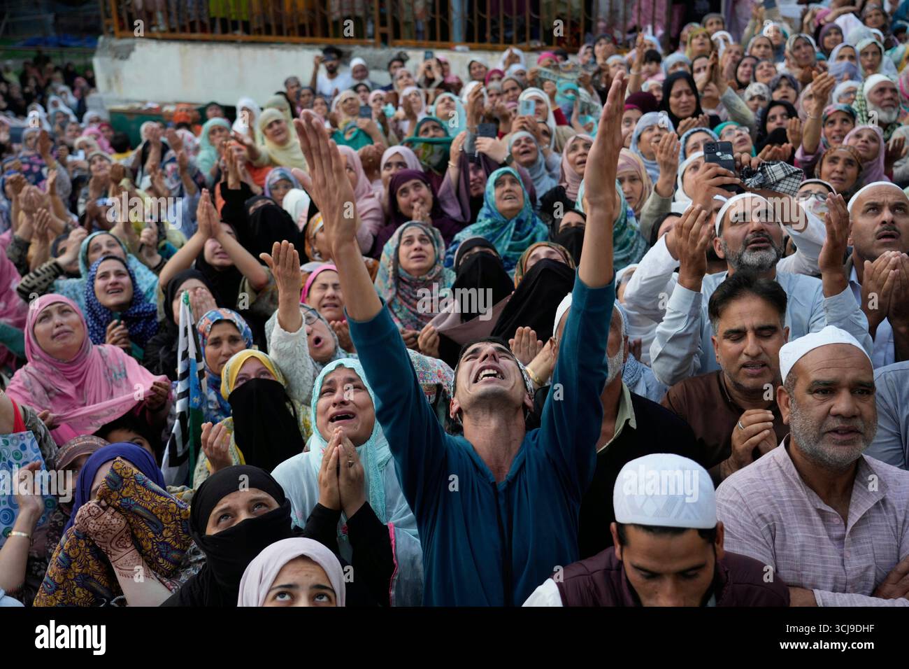 Kashmiri Muslim devotees pray as a head priest displays a relic ...