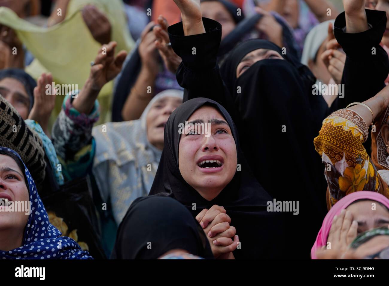Kashmiri Muslim devotees pray as a head priest displays a relic ...