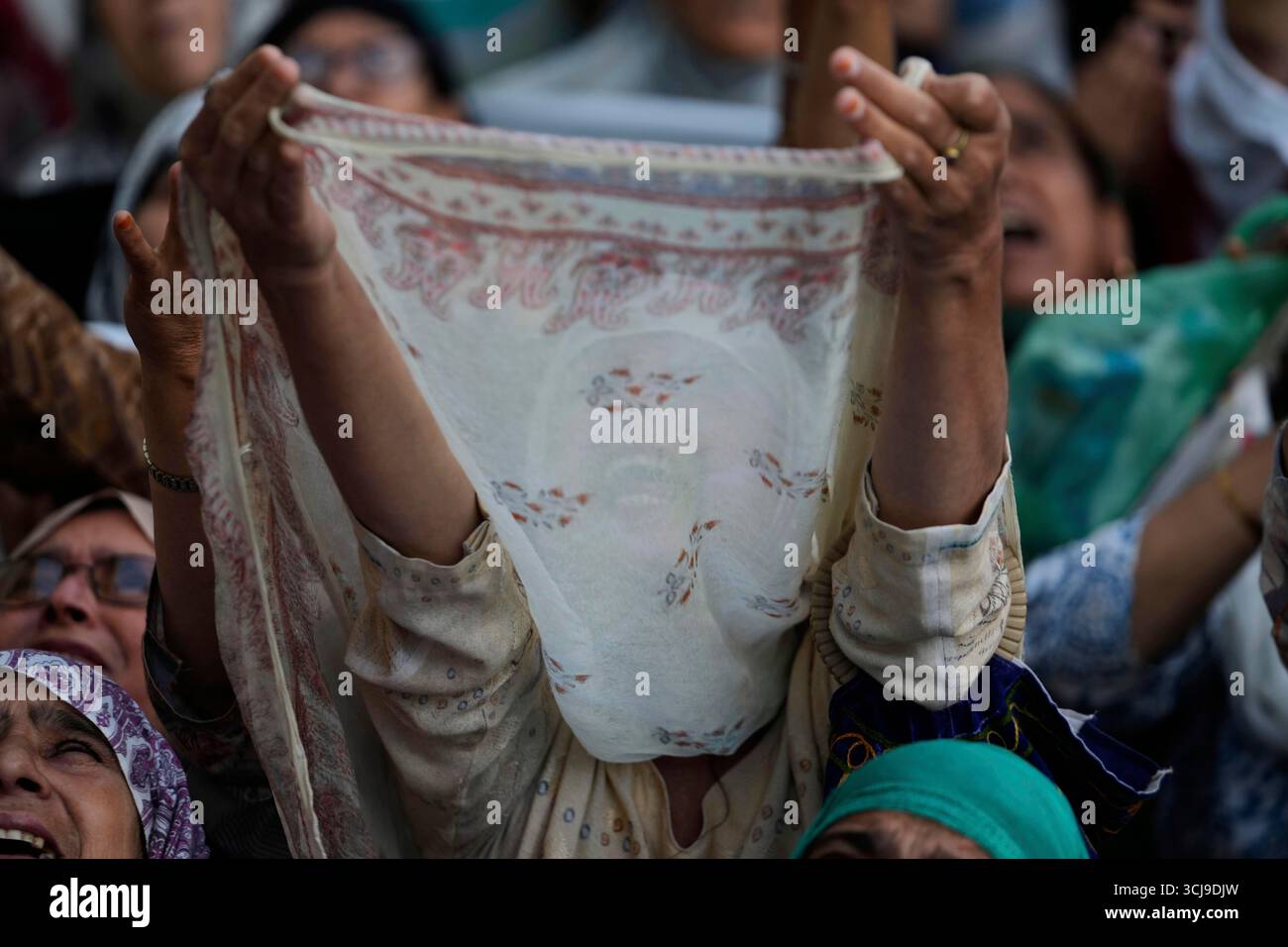 Kashmiri Muslim devotees pray as a head priest displays a relic ...
